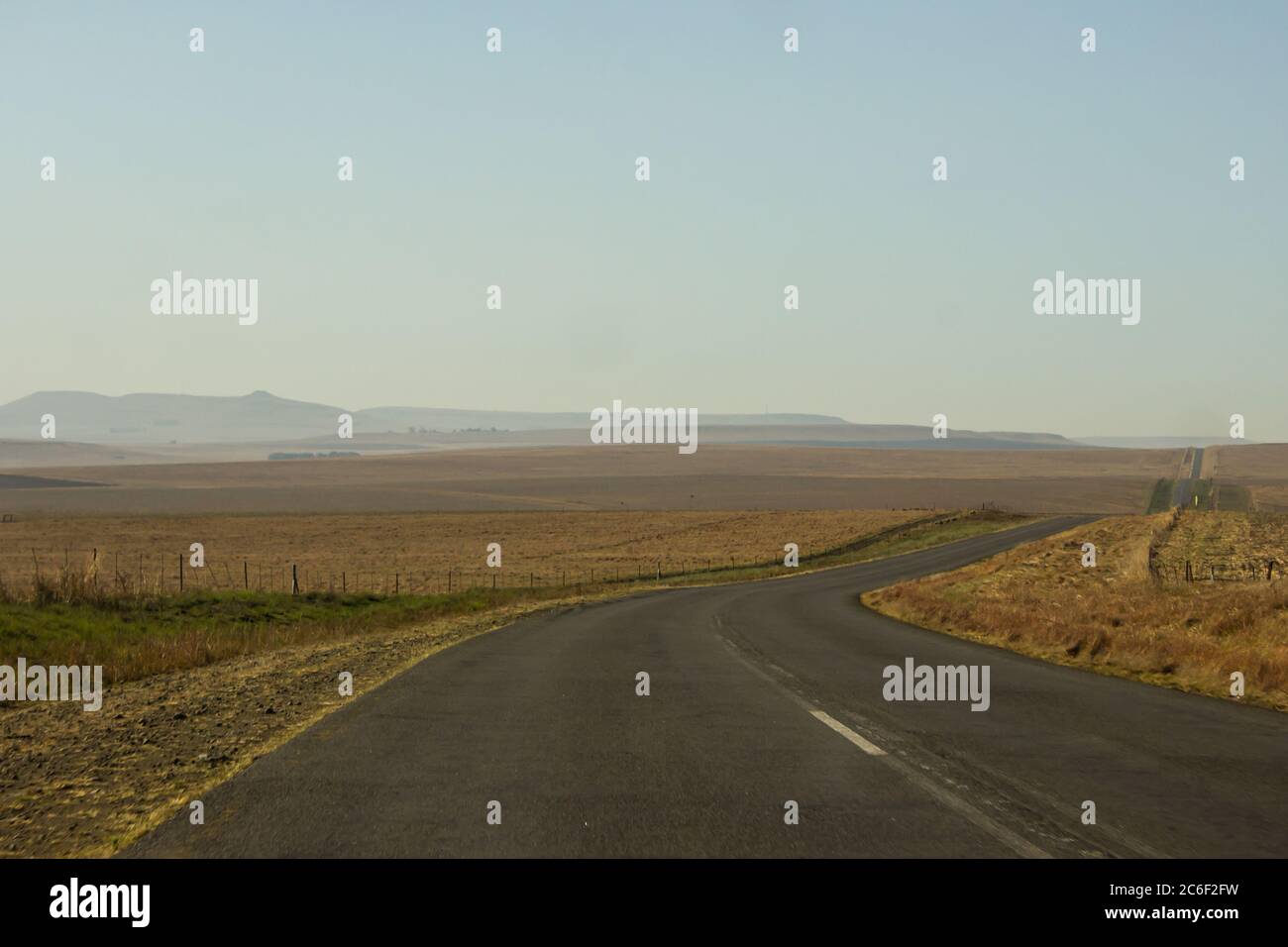 A tar road, winding through the veld of the Northern Free State, South ...