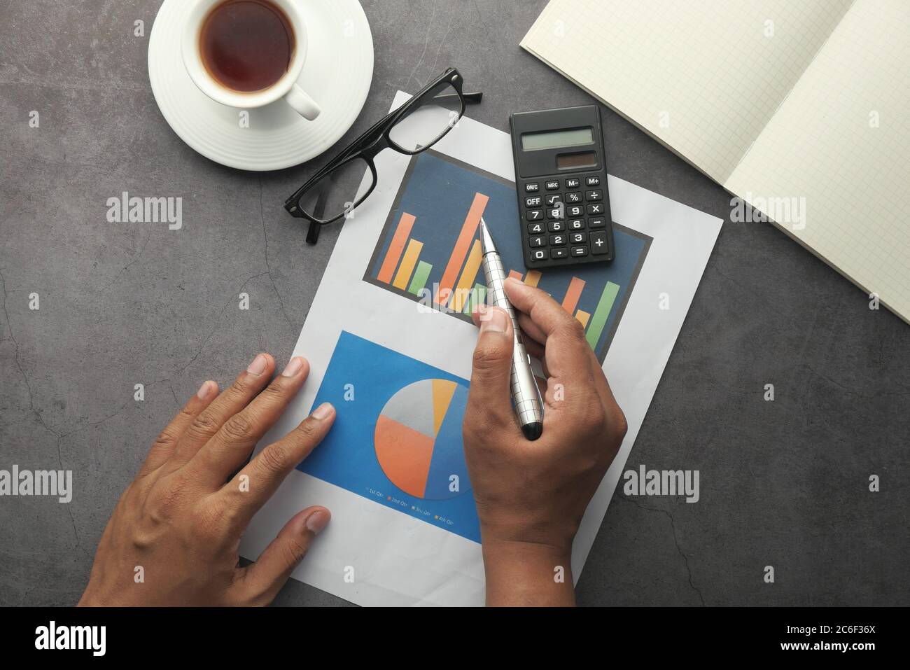 top view of man hand with pen analyzing bar chart on paper Stock Photo ...