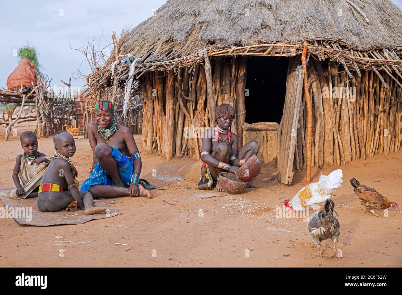 Black women with children of the Hamar / Hamer tribe in front of hut in ...