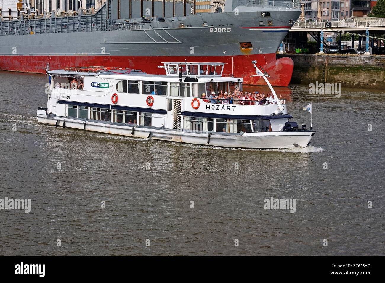 tour boat, passing large ship; River Scheldt; vacation, people, water ...