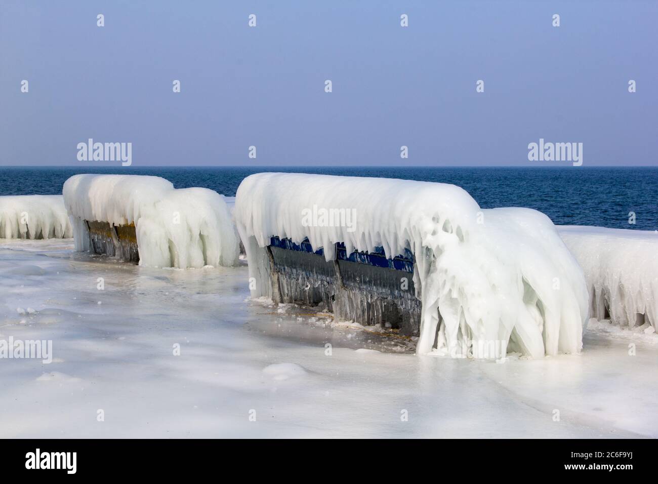 Frozen benches covered with ice at the lake side Stock Photo - Alamy