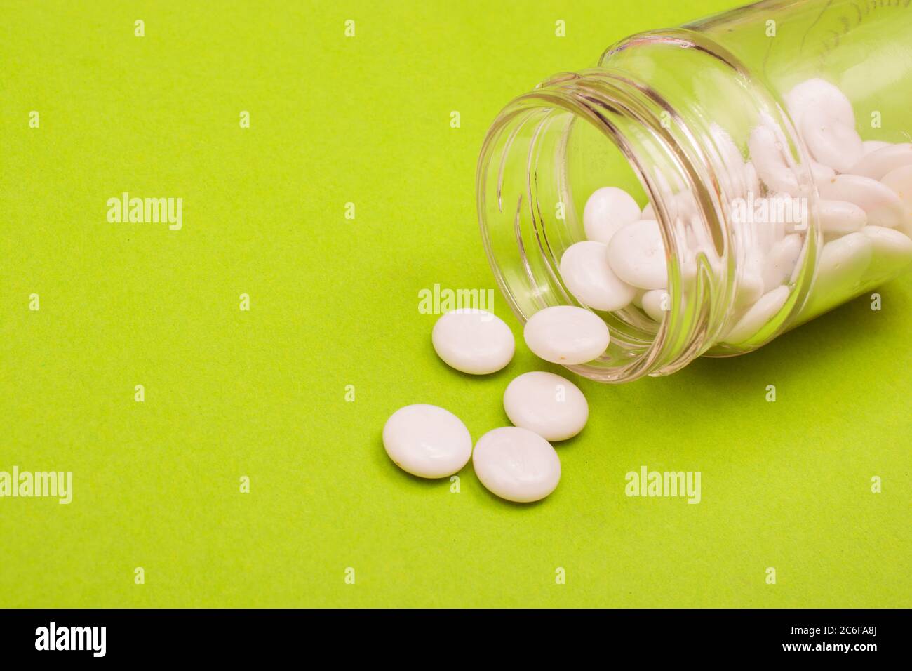 White pill and glass bottle container. Pharmaceutical industry ...