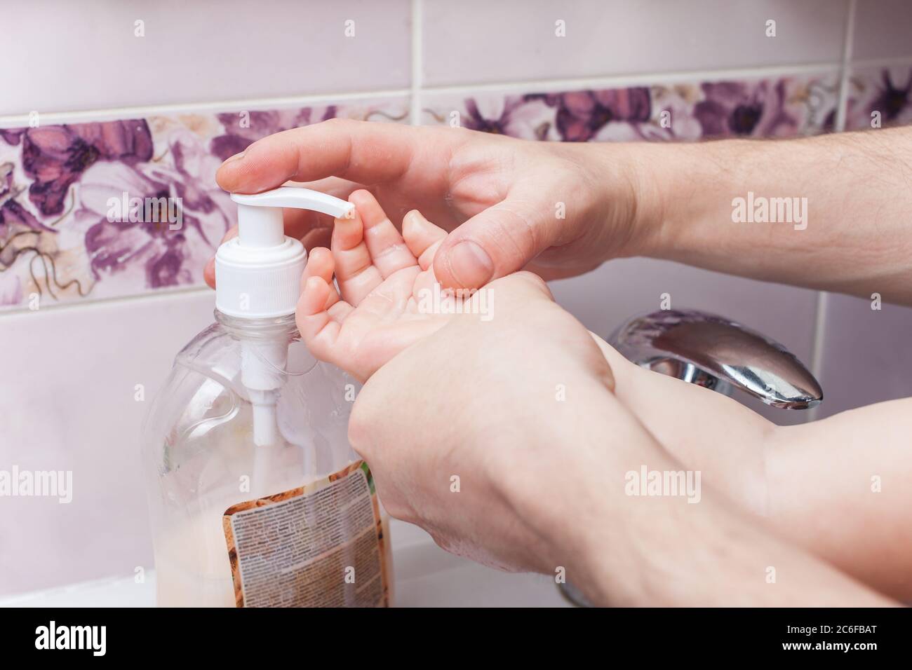 child washes hands in sink. jet of water from tap. Disinfection of ...