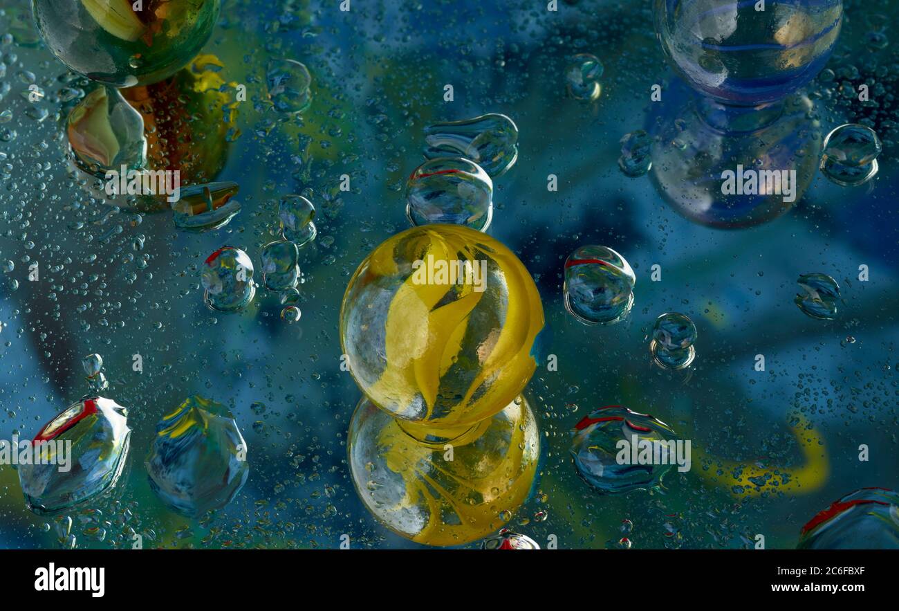 Single glass marble and reflection with a colour infused background and ...