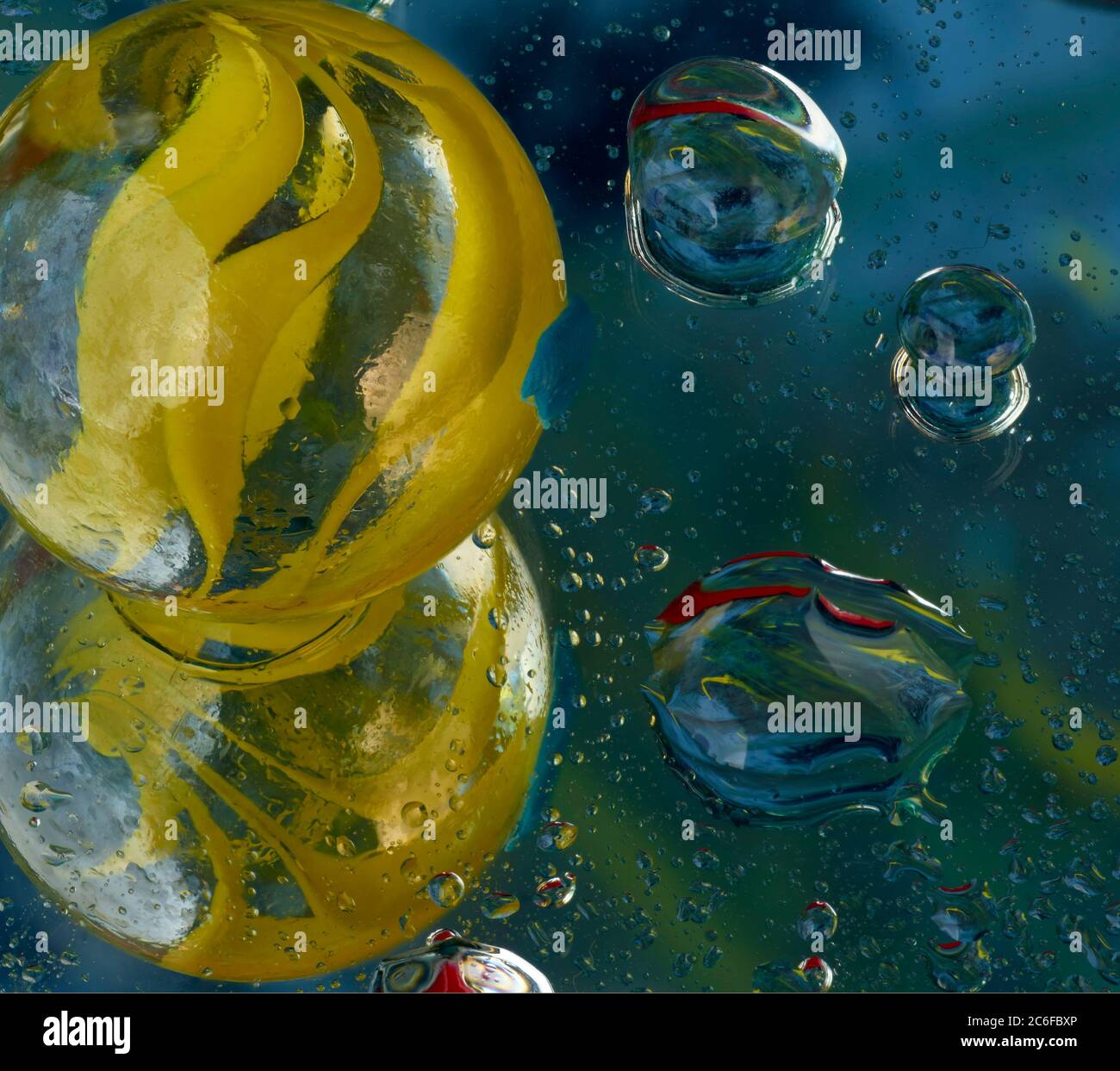 Single glass marble and reflection with a colour infused background and ...