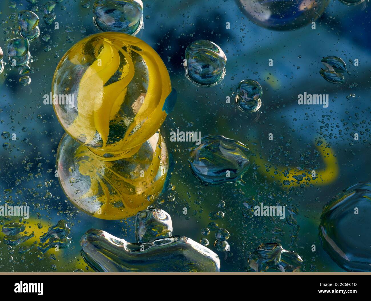 Single glass marble and reflection with a colour infused background and ...