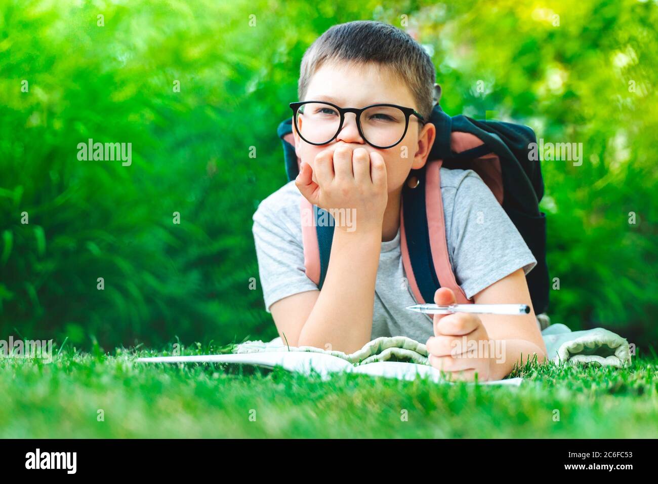 thoughtful kid boy in glasses thinking of solution. Funny schoolboy ...