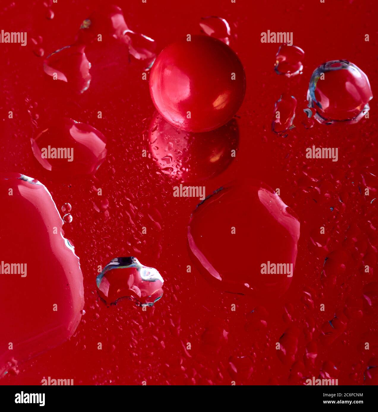 Red colour, water drops on solid background symbolising passion Stock ...