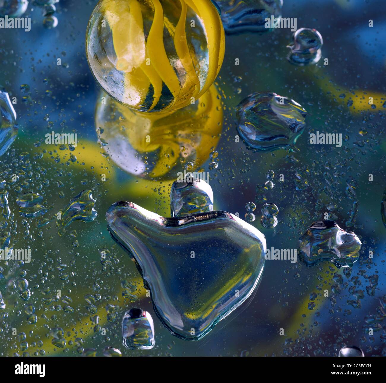 Single glass marble and reflection with a colour infused background and ...