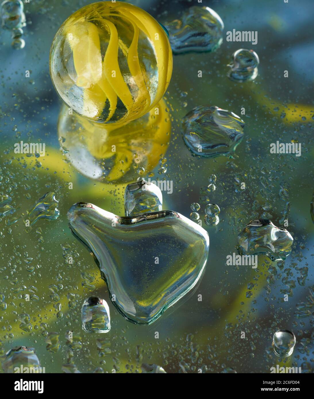 Single glass marble and reflection with a colour infused background and ...