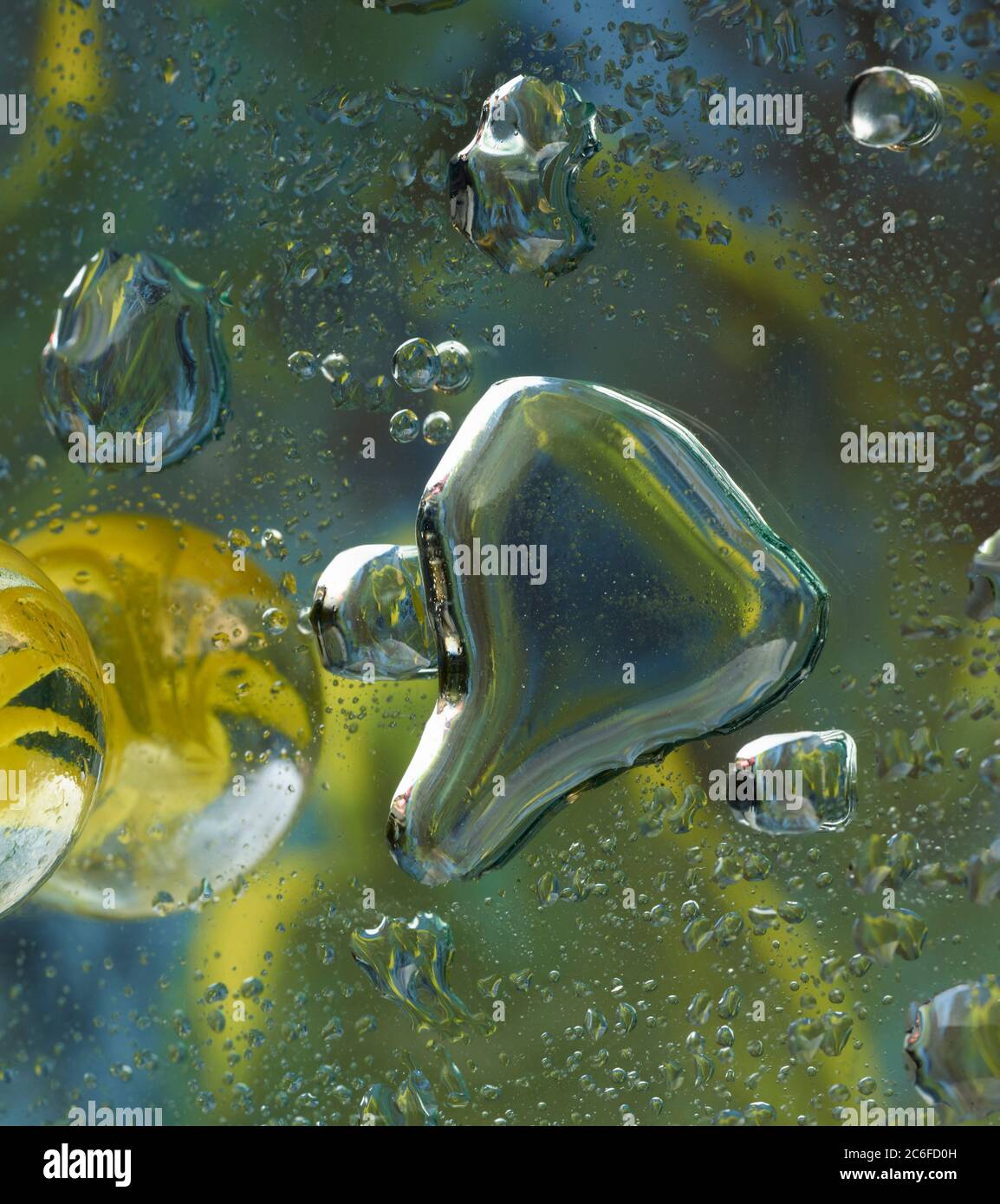 Single glass marble and reflection with a colour infused background and ...