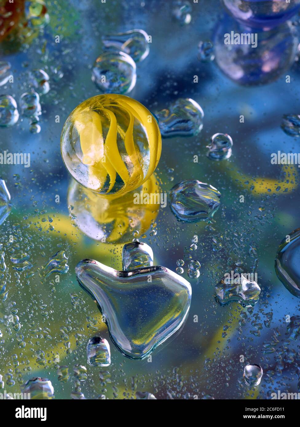 Single glass marble and reflection with a colour infused background and ...