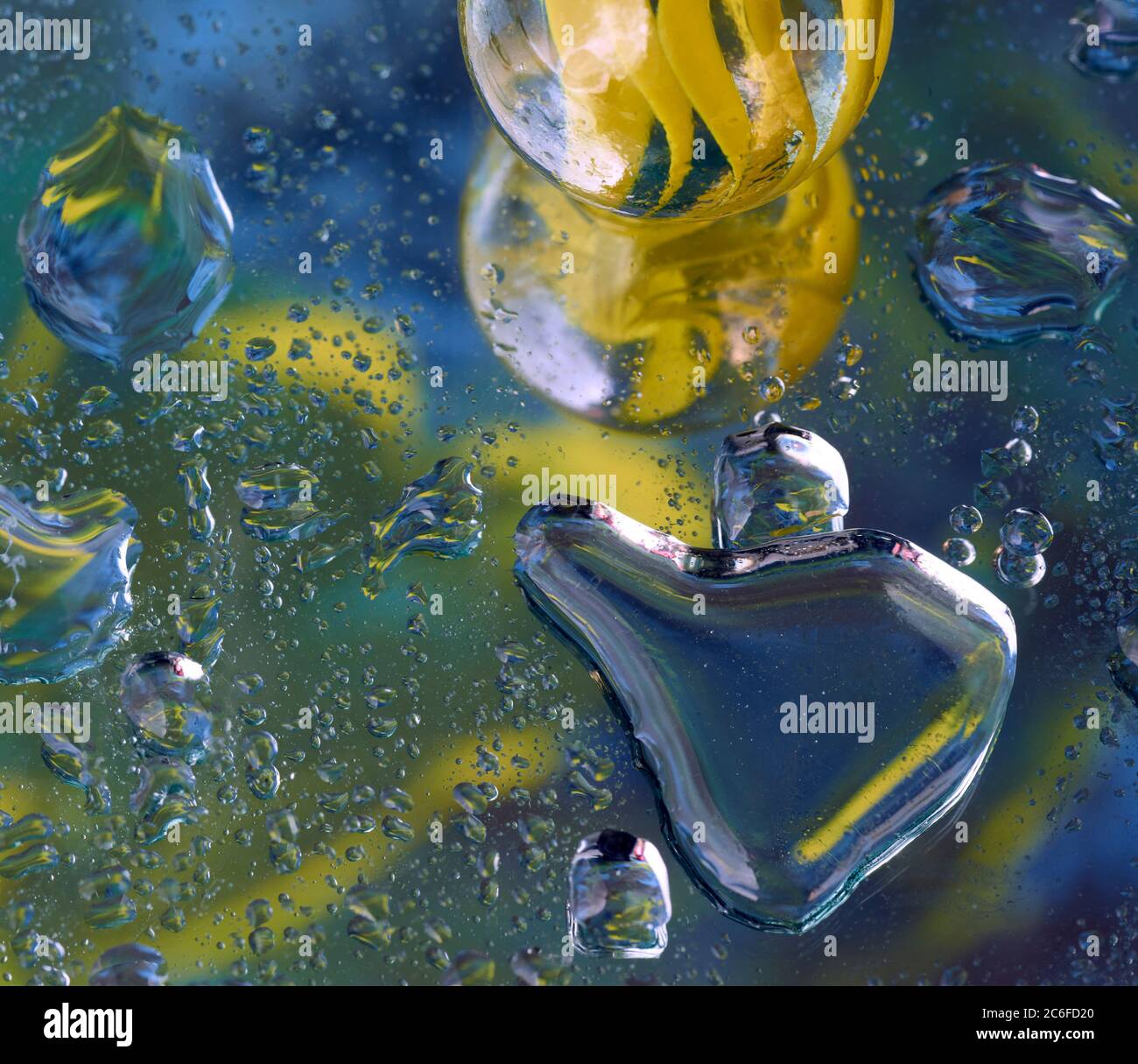 Single glass marble and reflection with a colour infused background and ...