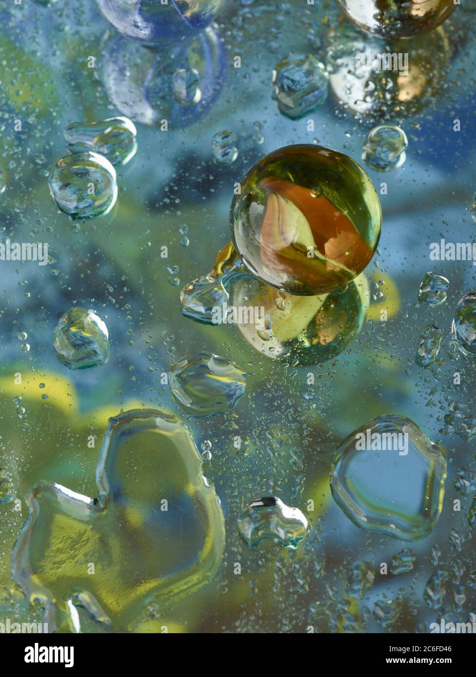 Single glass marble and reflection with a colour infused background and ...