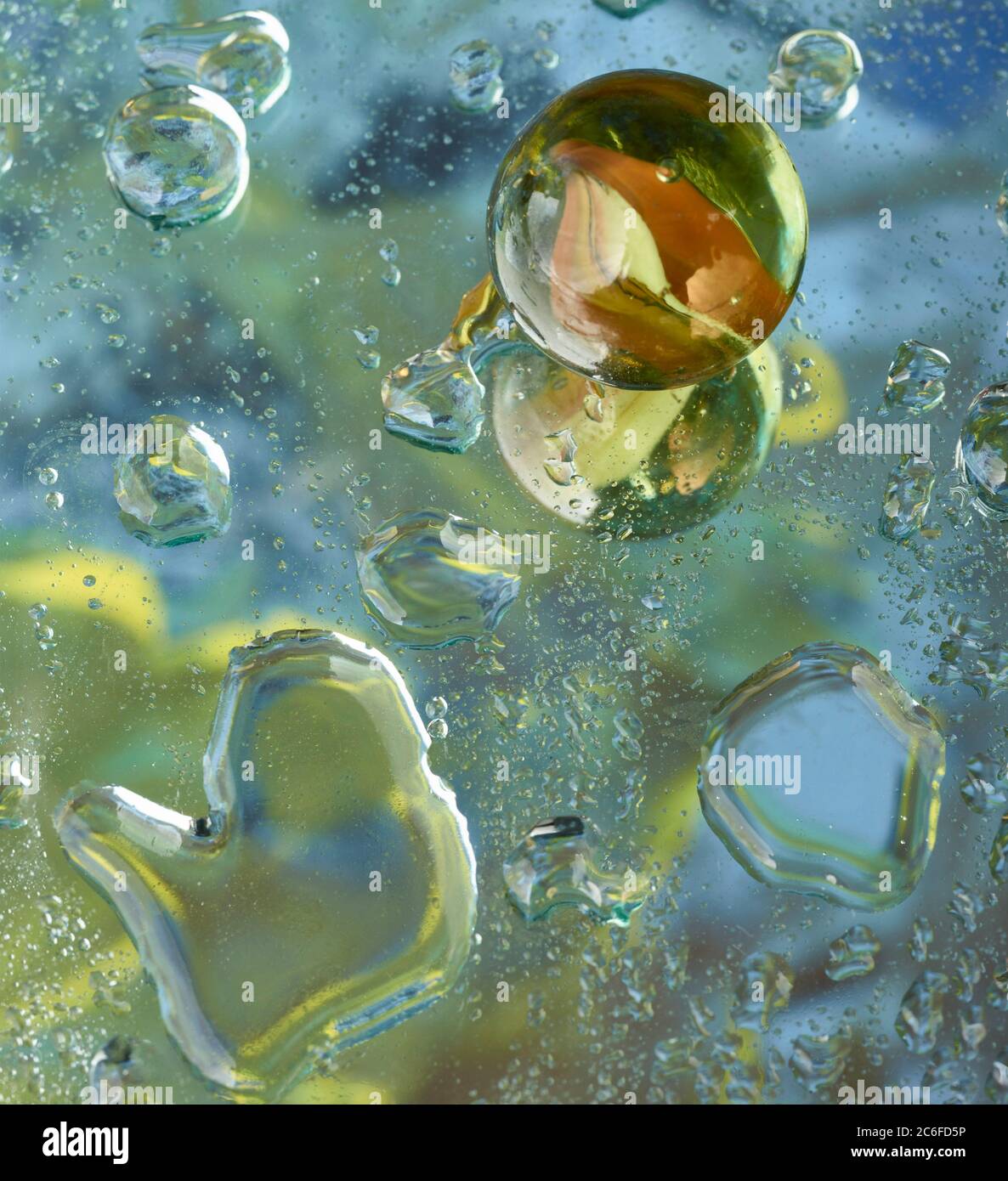 Single glass marble and reflection with a colour infused background and ...