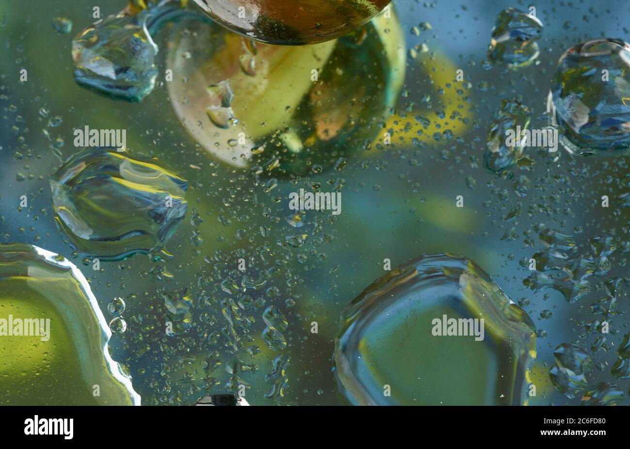 Single glass marble and reflection with a colour infused background and ...