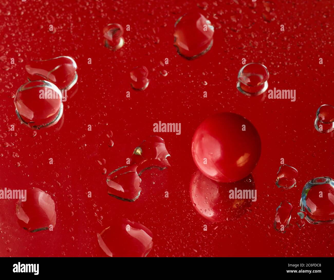 Red colour, water drops on solid background symbolising passion Stock ...