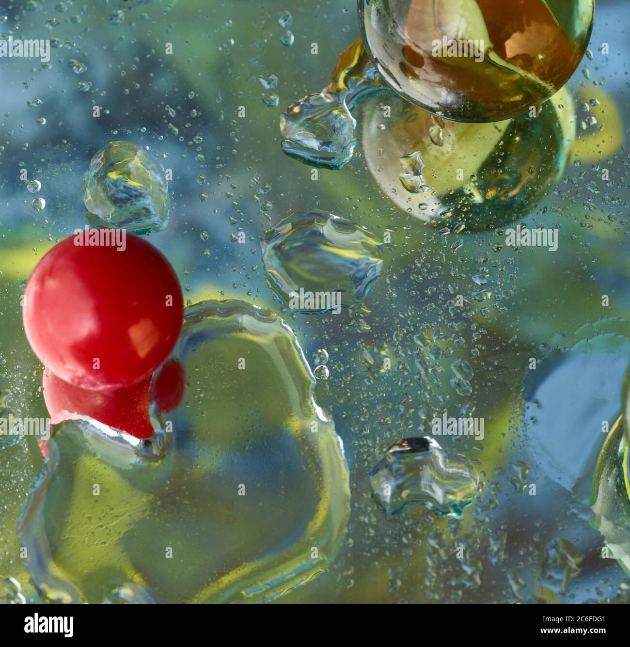 Single glass marble and reflection with a colour infused background and ...