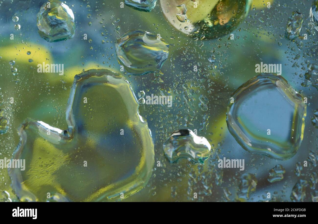 Single glass marble and reflection with a colour infused background and ...