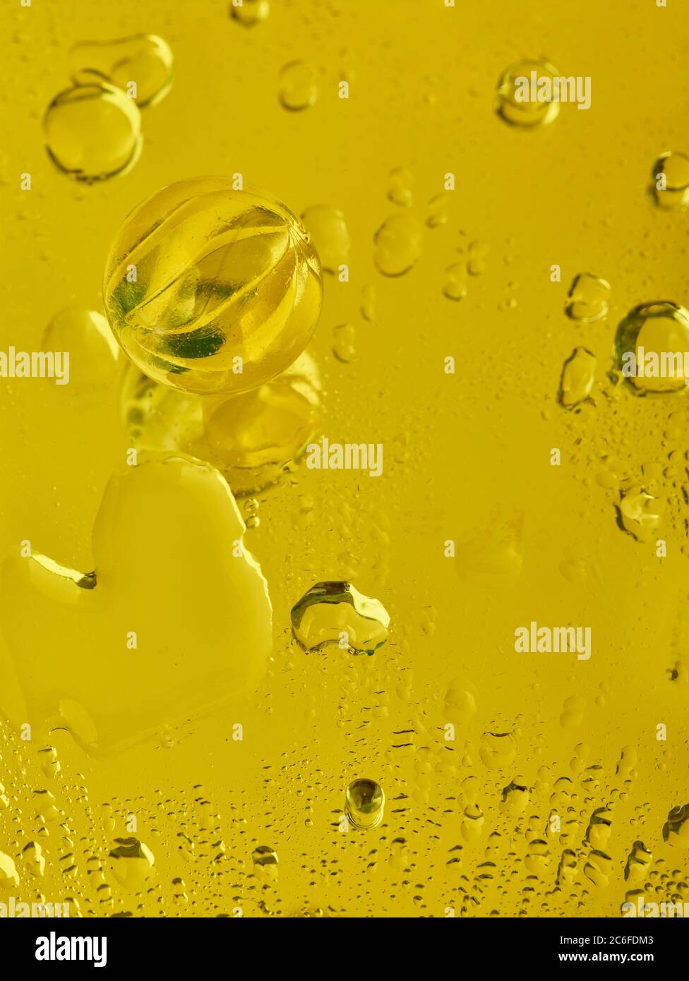 Single glass marble and reflection with a colour infused background and ...