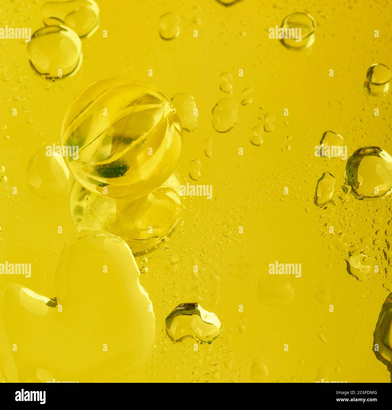 Single glass marble and reflection with a colour infused background and ...