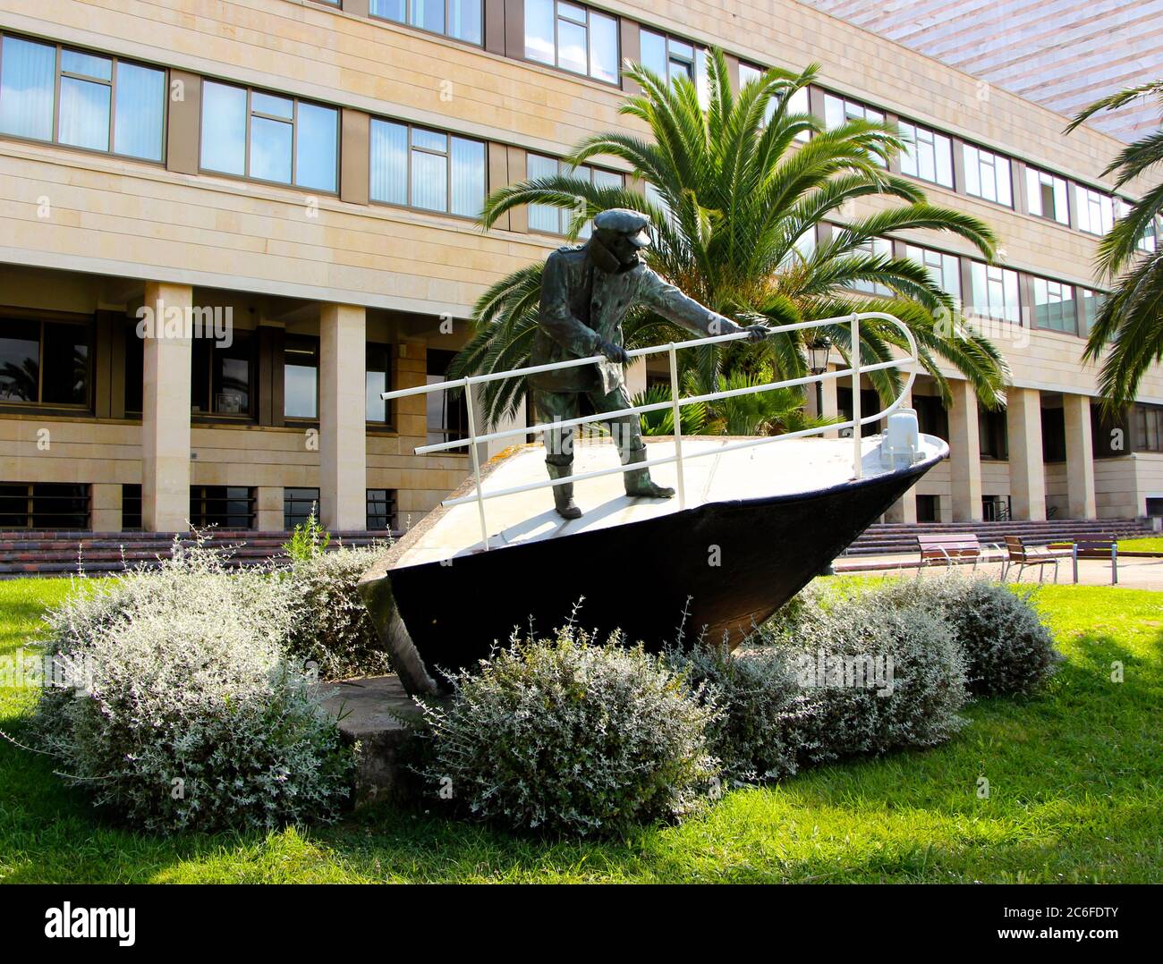 Sculpture of a merchant sailor standing at the bow of a boat holding ...