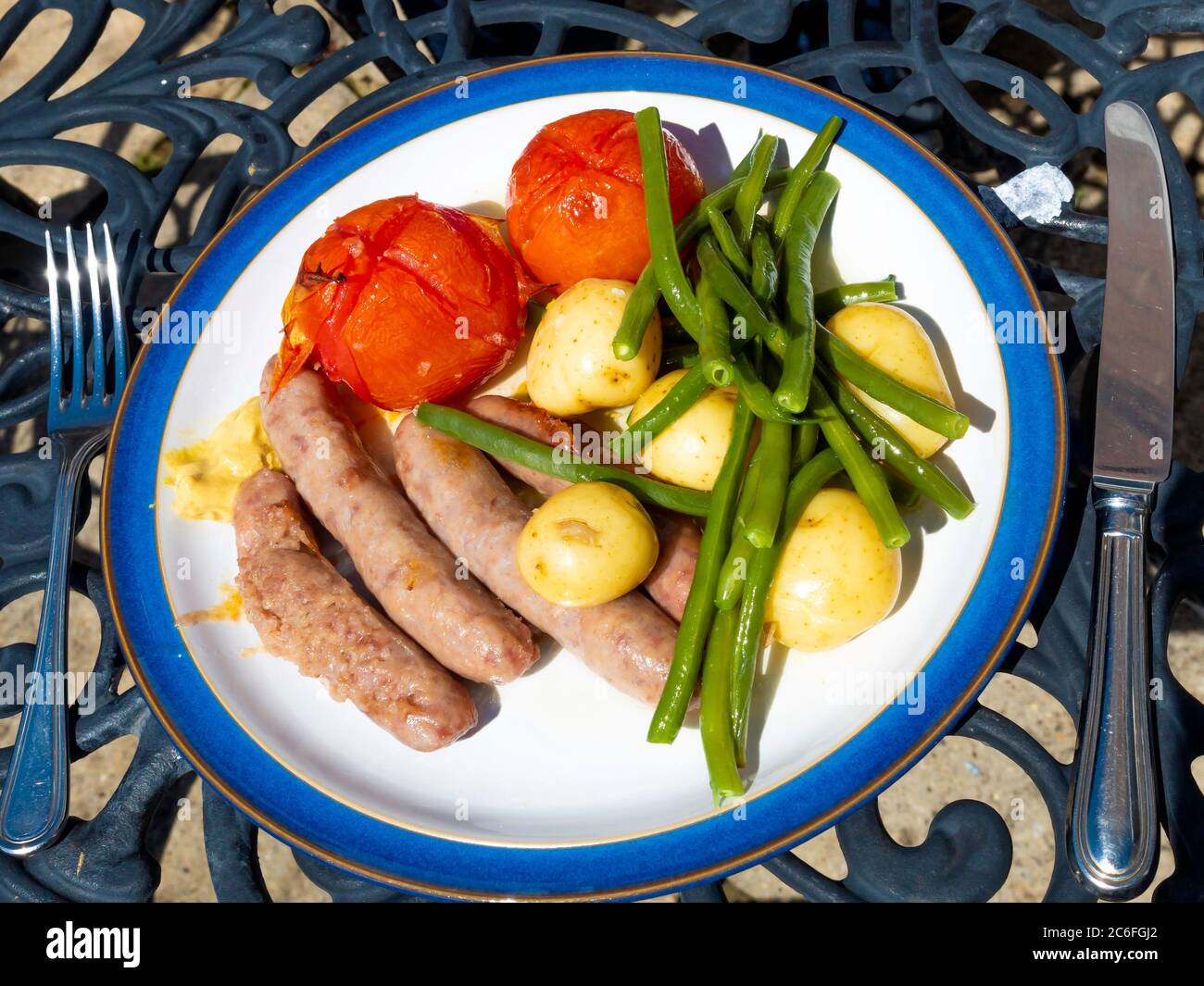 Lunch main course with green beans new potatoes and grilled tomatoes ...