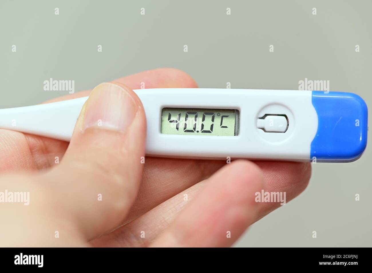 Hand Holding A Thermometer With A High Fever Temperature Of More Than Hand Holding A Thermometer With A High Fever Temperature Of More Than