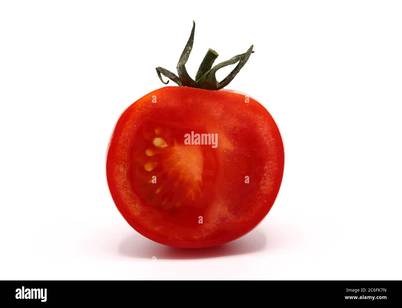 Half ripe red tomato on a light background. Natural product. Natural ...