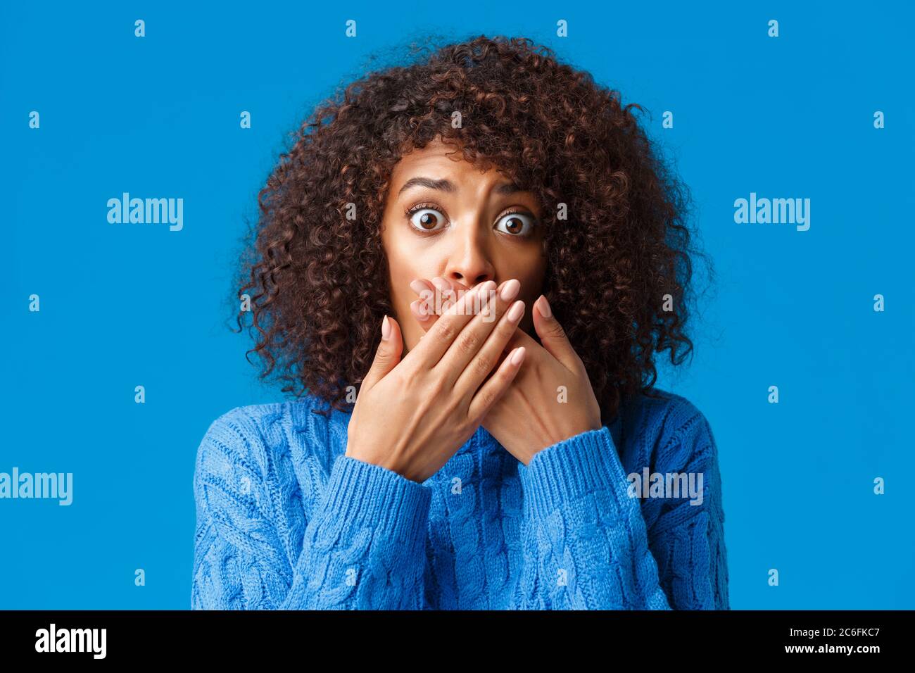 Close-up portrait shocked and scared african-american girl home alone ...