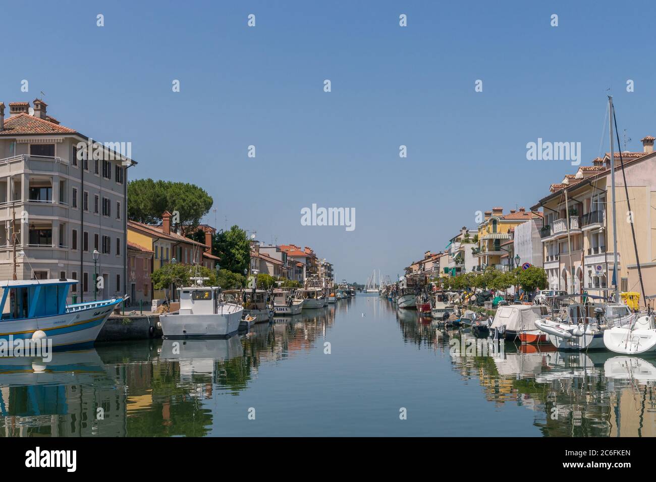 Grado, Italy - June 28th, 2019: View along one of the water alleys of ...