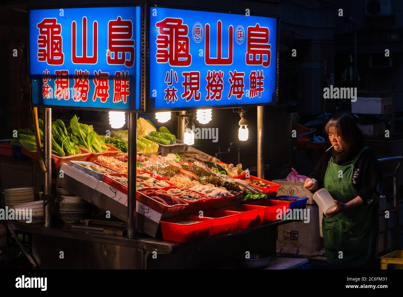 Taipei, Taiwan - Dec. 24th, 2018: A lady is going to prepare seafood ...
