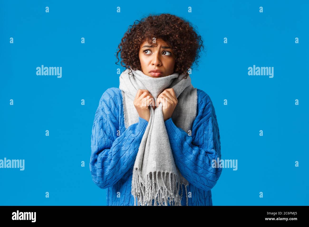 Silly and sad, gloomy african-american girl looking outside windy snowy ...