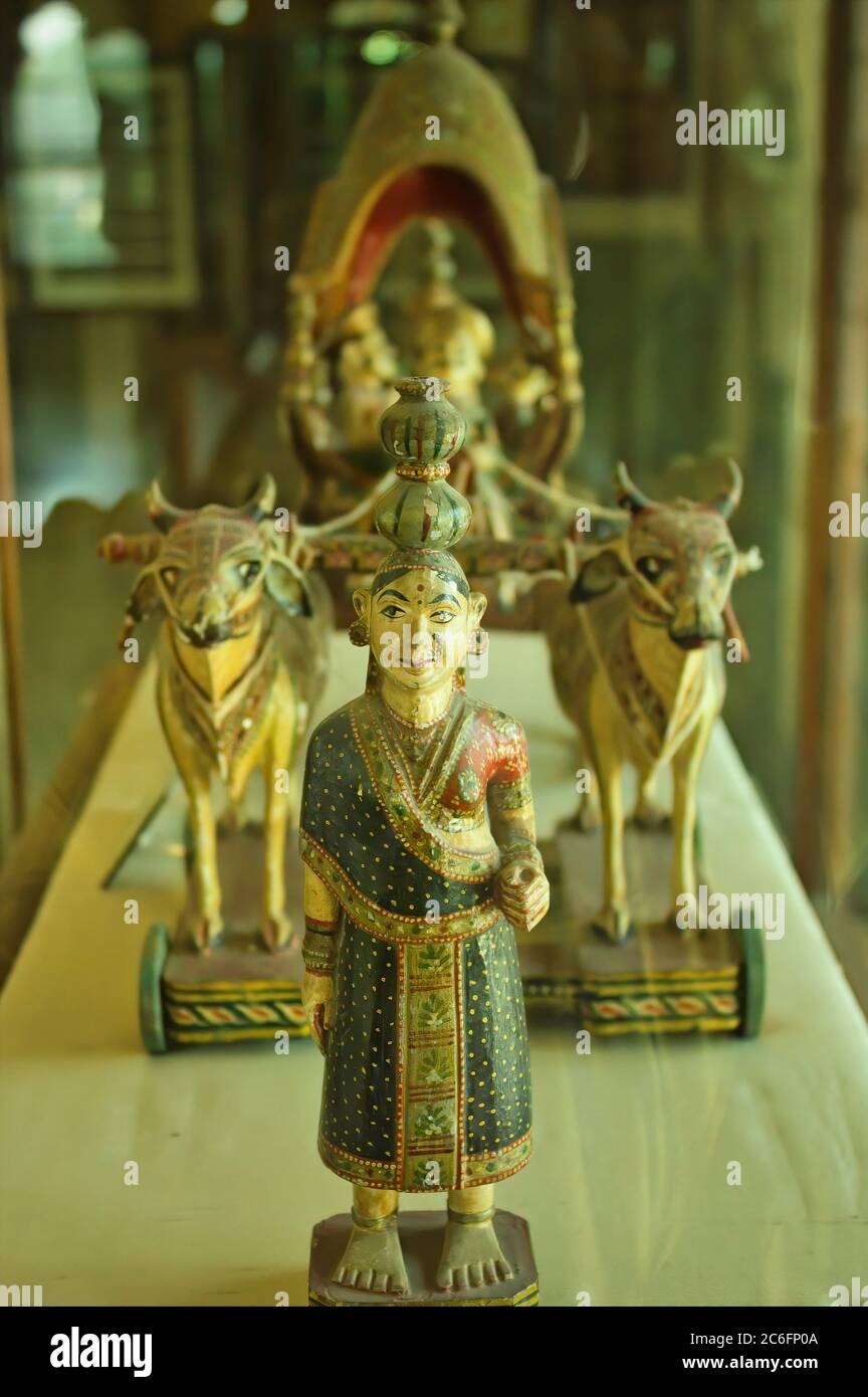 A woman in Indian dress carrying earthen pitcher on head leading a ...
