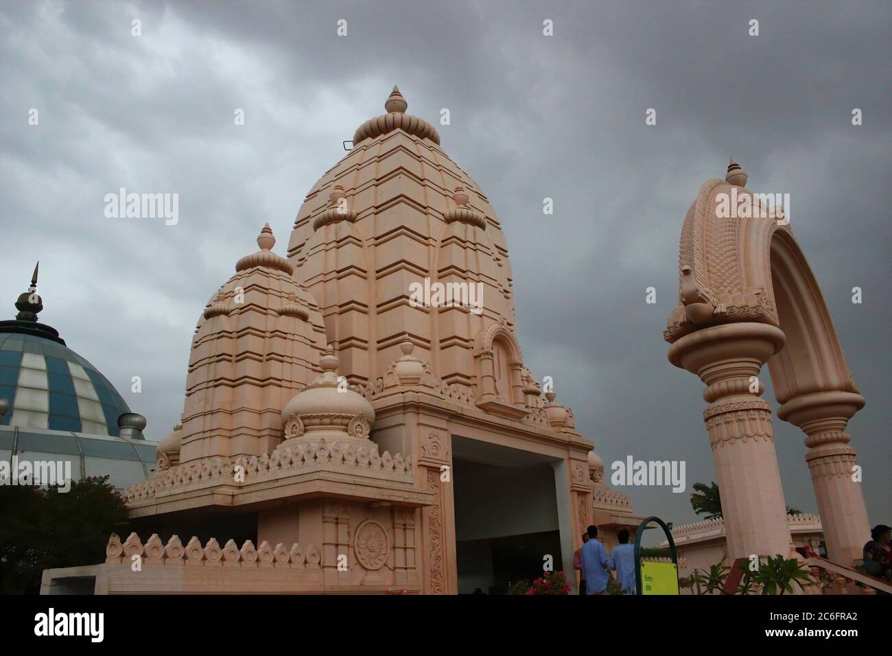 A hindu temple located in Mathura against dramatic black cloud in Uttar ...