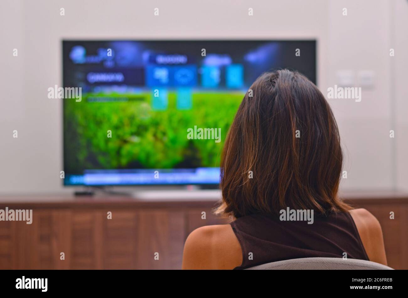 Women watching tv shows and use remote controller Stock Photo - Alamy