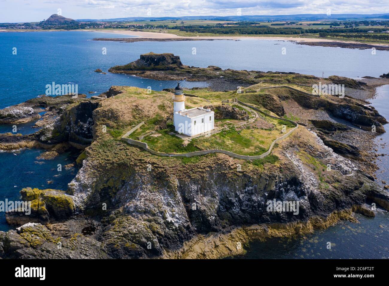 Aerial view of Fidra Island and lighthouse on Firth of Forth in East ...