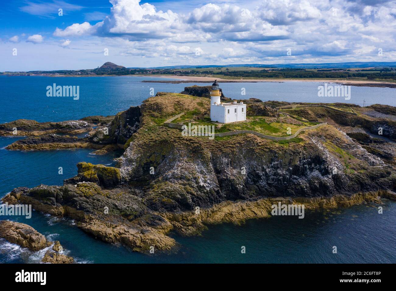 Aerial view of Fidra Island and lighthouse on Firth of Forth in East ...