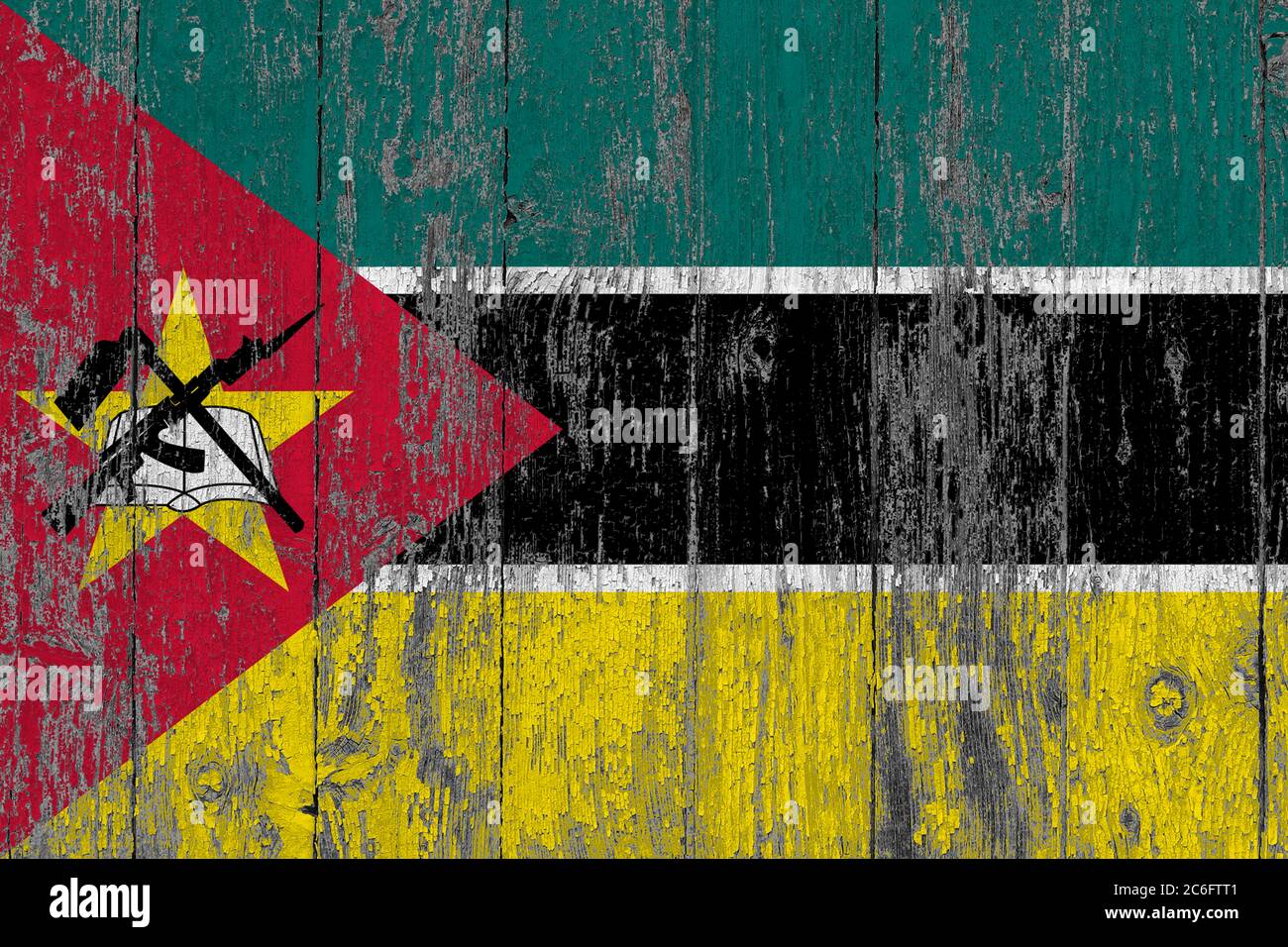 Mozambique flag on grunge scratched wooden surface. National vintage ...
