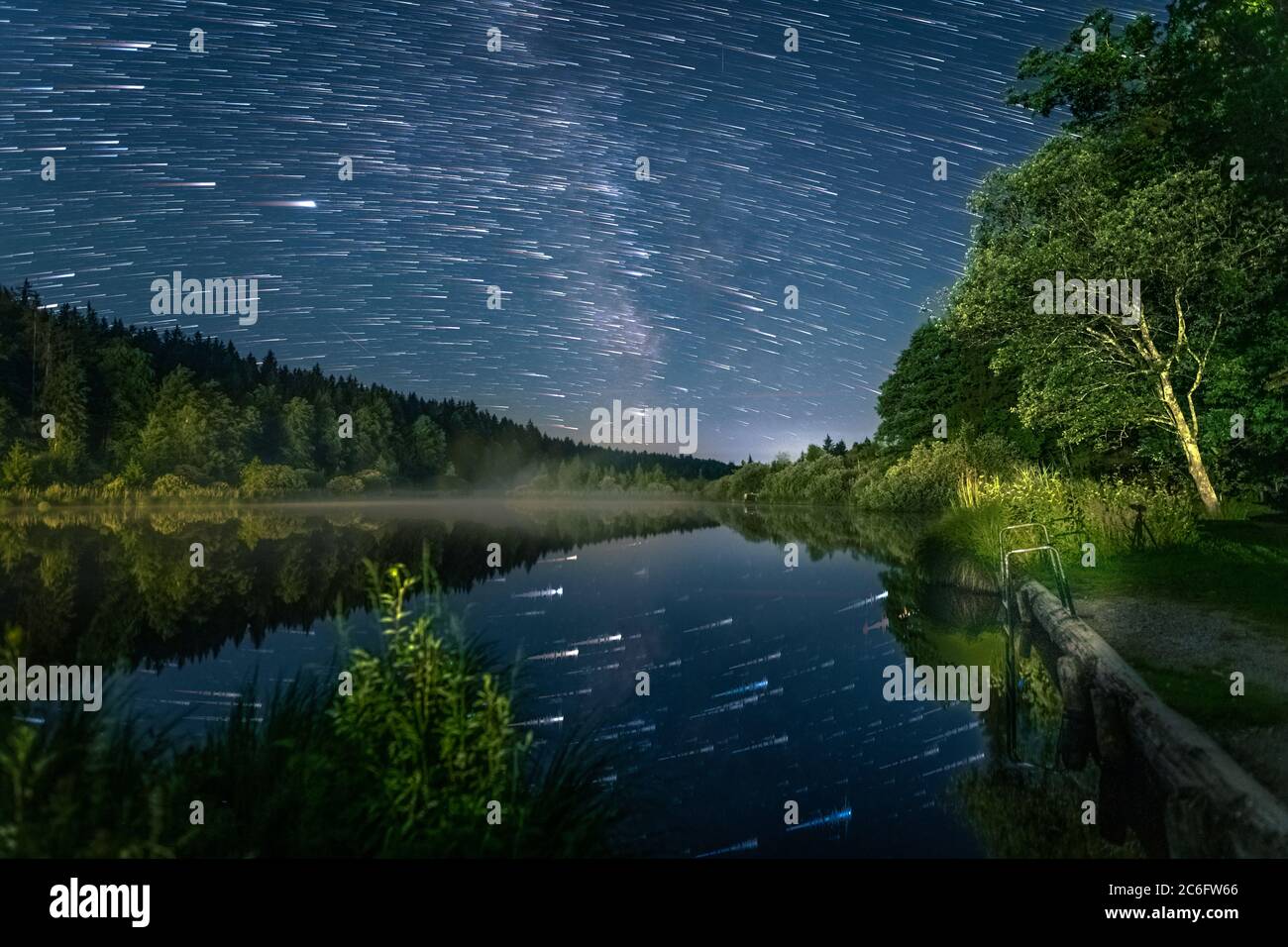 Comet modus - Stars flying over a beautiful lake with refections of the ...