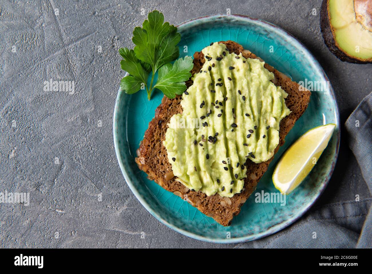 Avocado toast on whole grain bread, mashed avocado with sesame seeds ...