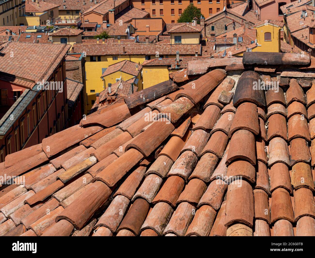 aerial view of terracotta roof tiles with Bologna in the distance ...