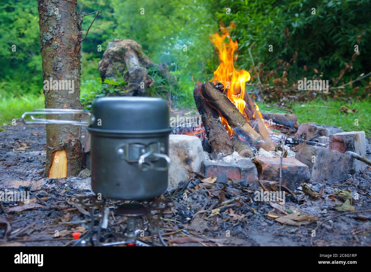 cooking tea over a fire, cooking on a hike Stock Photo - Alamy