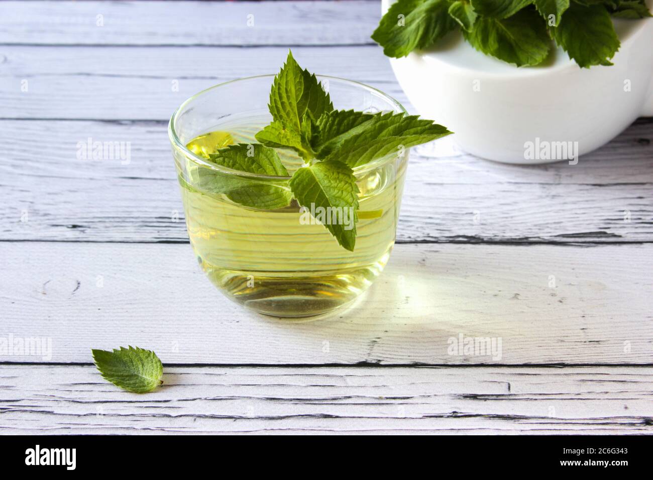 Fresh mint tea concept on a wooden background. Mint tea in a ...