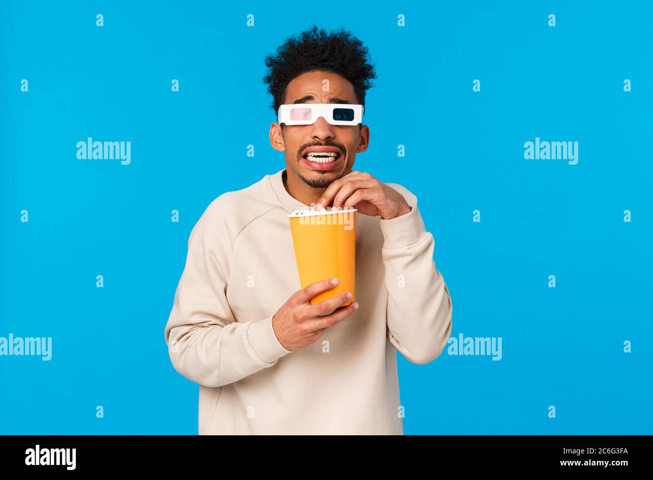 So scary. Trembling and terrified african-american hipster guy watching ...