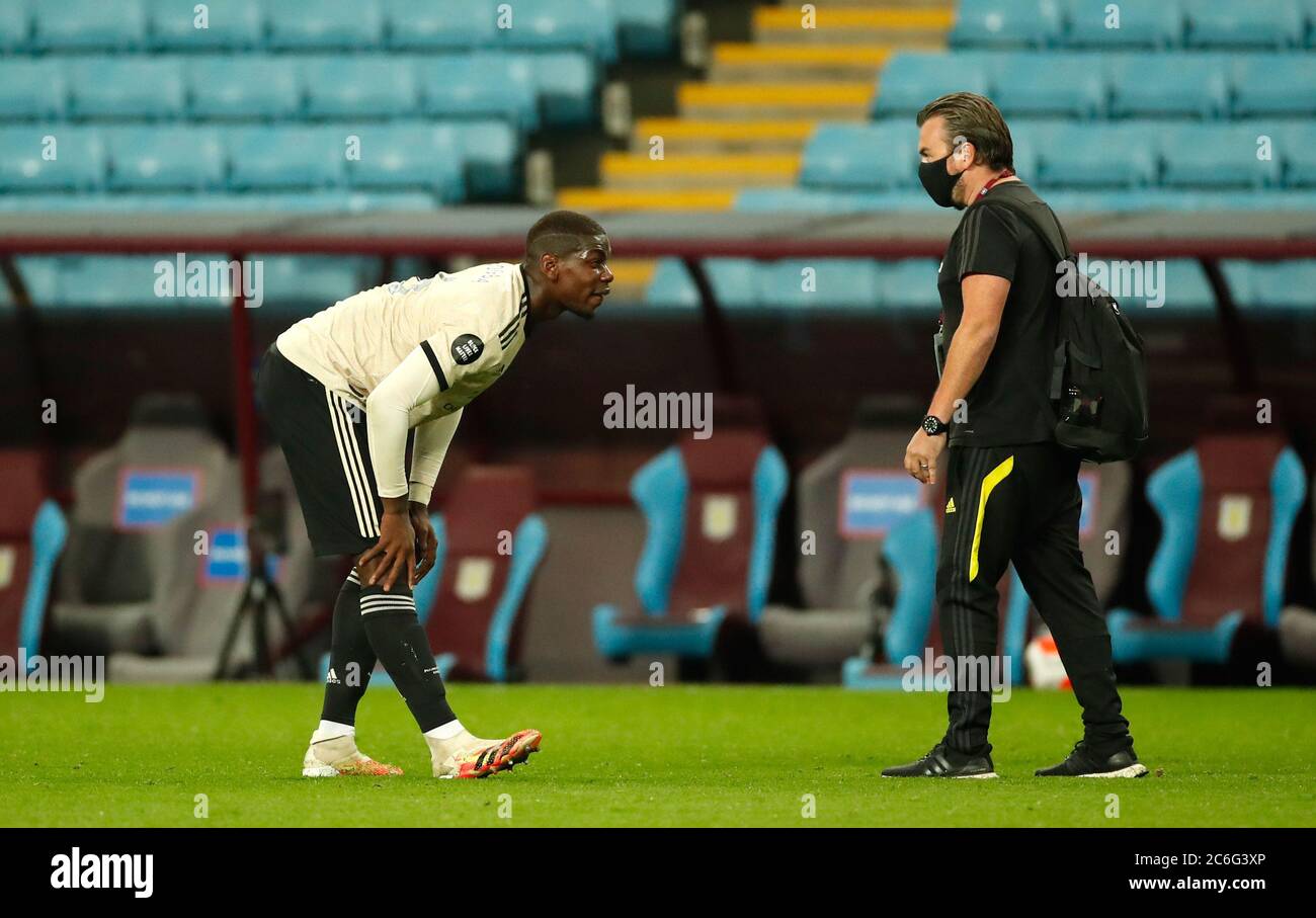 Manchester United's Paul Pogba (left) stretches after going down late ...