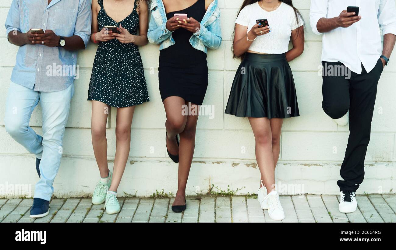 Group of friends watching smart mobile phones. Group of multicultural ...