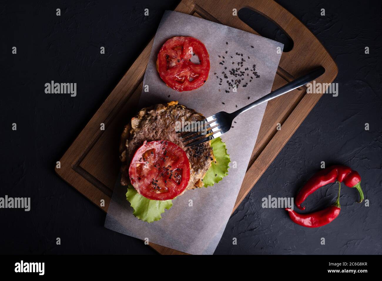 top view, inside burger, meat cutlet with chopped tomatoes, wooden ...