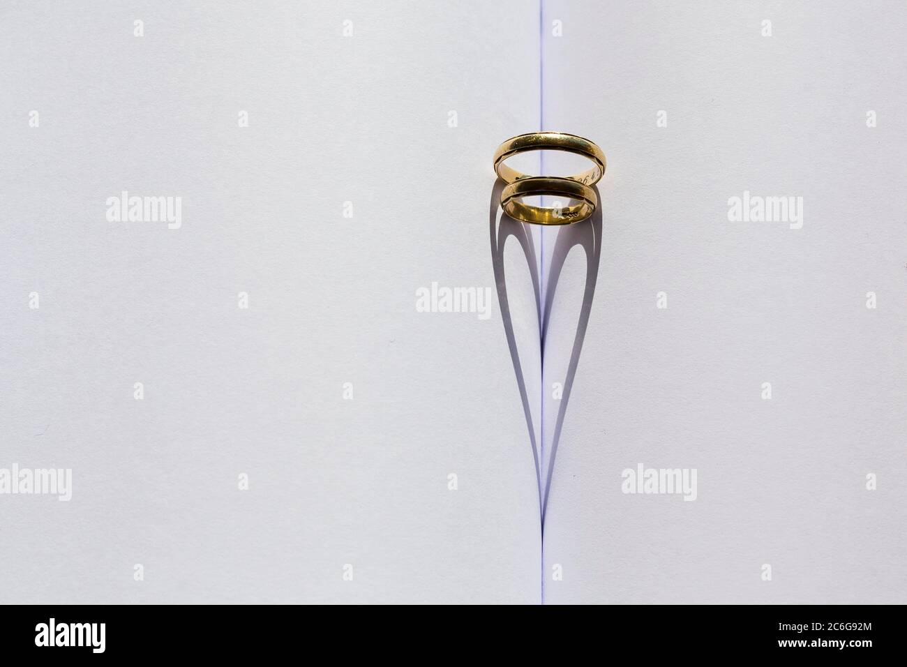 Two rings in the fold of an empty book hi-res stock photography and ...