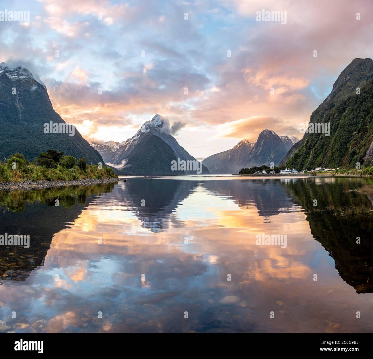 Mitre Peak, reflection in water, sunset, Milford Sound, Fiordland ...